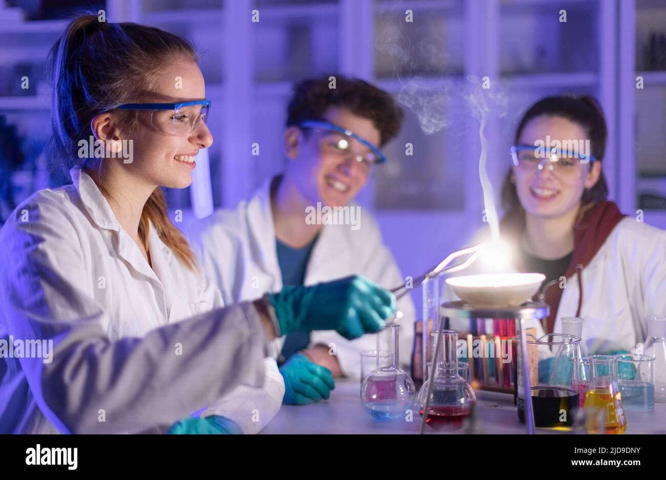 Excited science students doing chemical experiment in the laboratory at ...