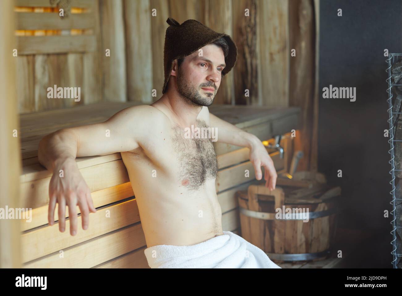 Serious man having a sauna bath in a steam room Stock Photo - Alamy