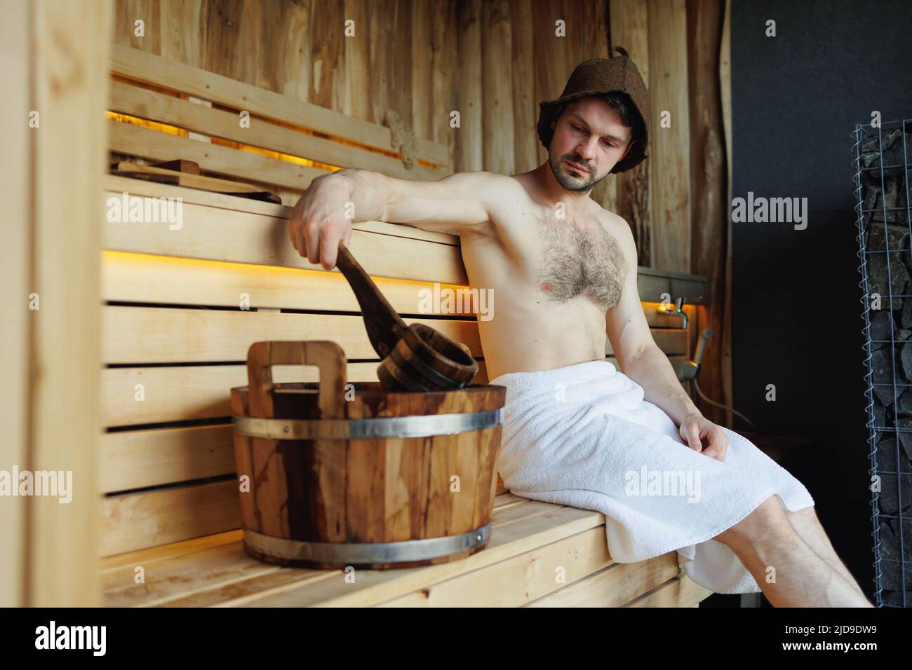 Attractive man relaxing in Finnish sauna Stock Photo - Alamy