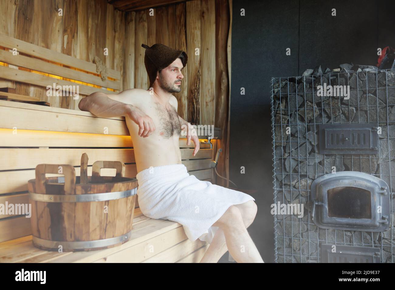 Man in finnish sauna sweating and relaxing Stock Photo - Alamy