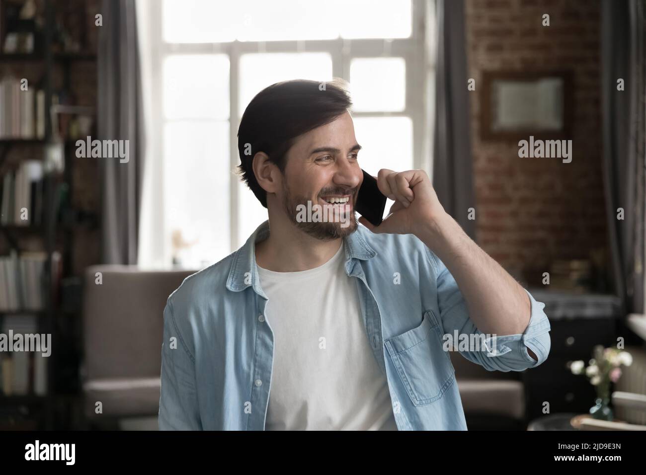 Happy successful businessman standing in office make business call ...