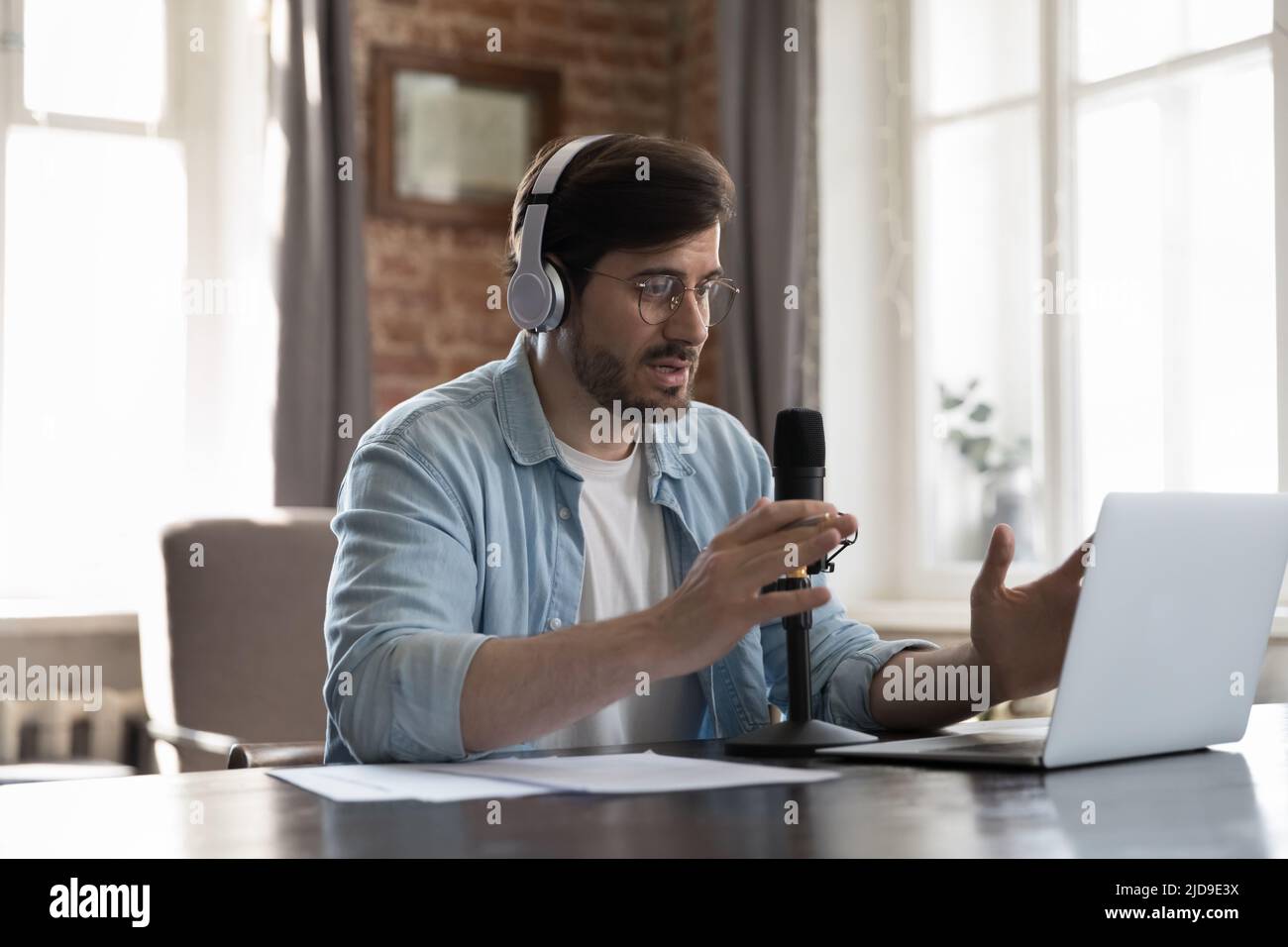 Man streamer wear headphones records podcast, makes speech into ...