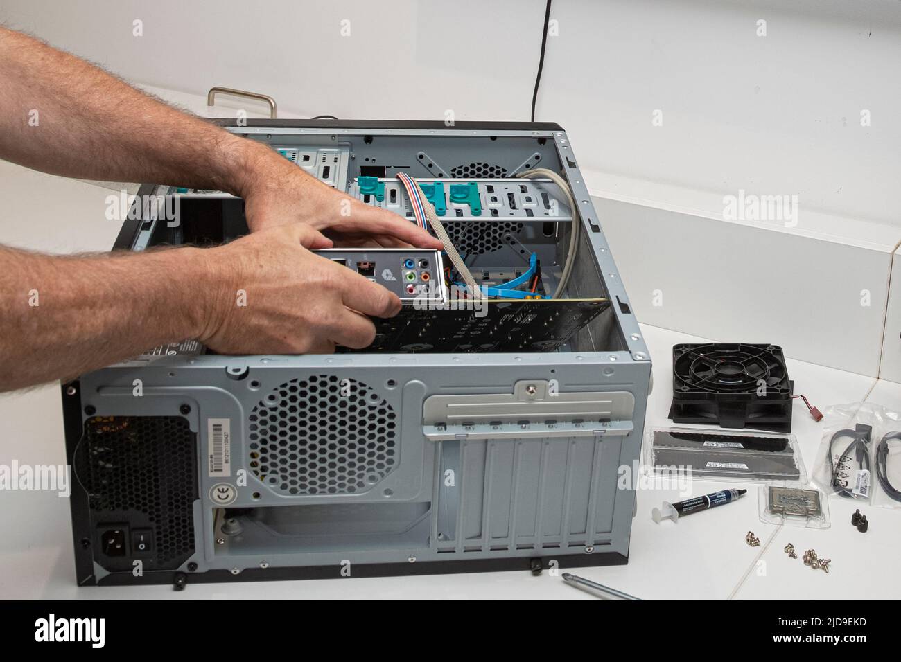 A system administrator installs a motherboard in a computer case Stock ...