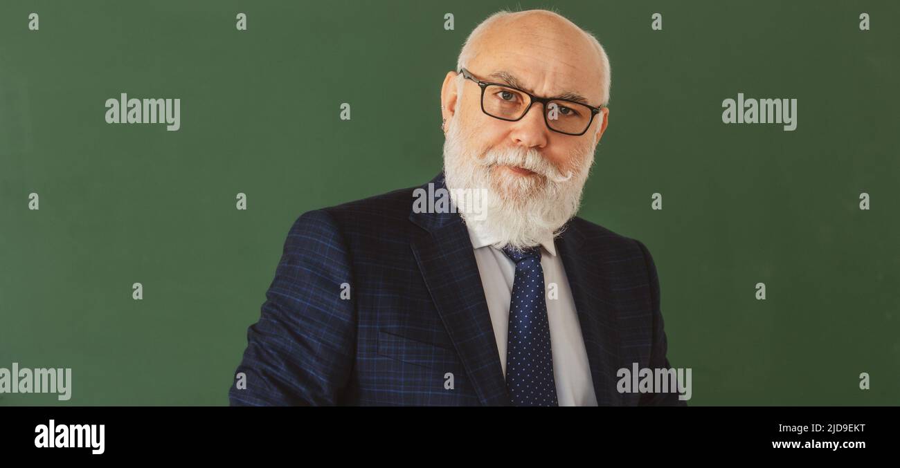 Elderly teacher. Funny professor or scientist in a elegant suit. Copy ...