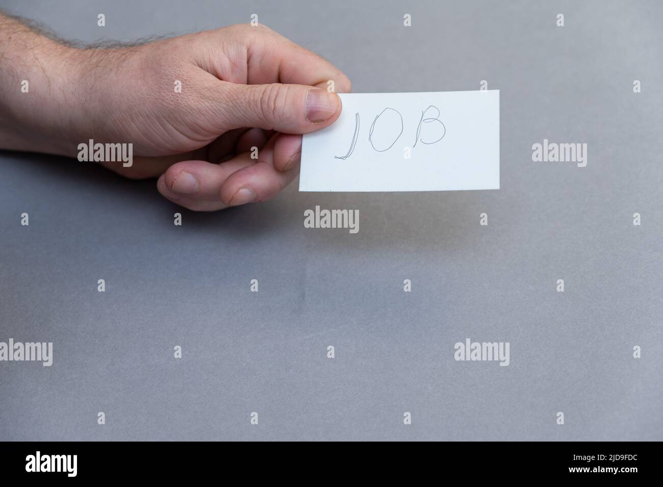 Job. Handwritten gray lettering. Open male palm with white business ...