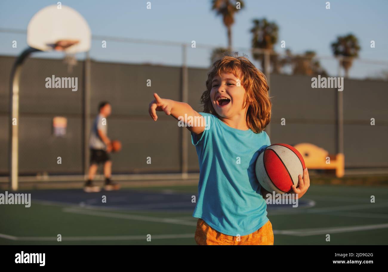 Basketball kids game. Cute little boy laughing and holding a basketball ...