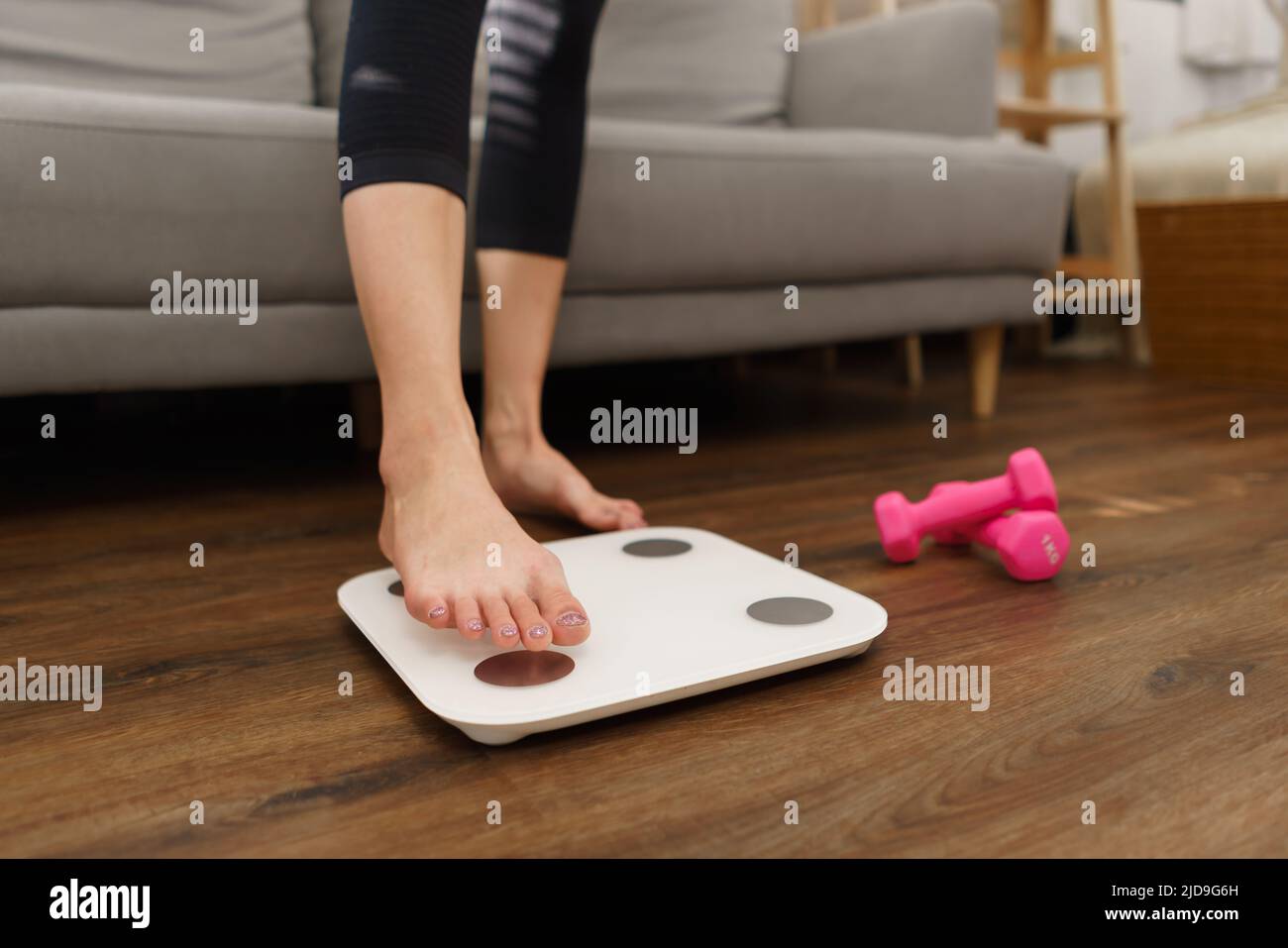 Healthy and weight loss concept, Young Asian woman stepping on weighing ...