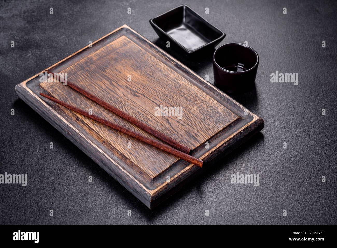 Wooden sushi sticks on a dark concrete background. Japanese Asian ...