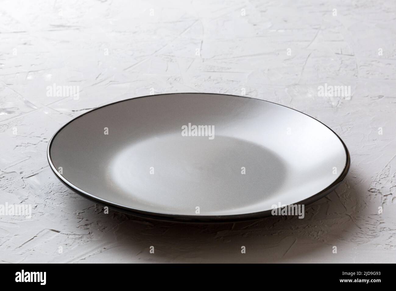Perspective view of empty colorful plate on cement background. Empty ...