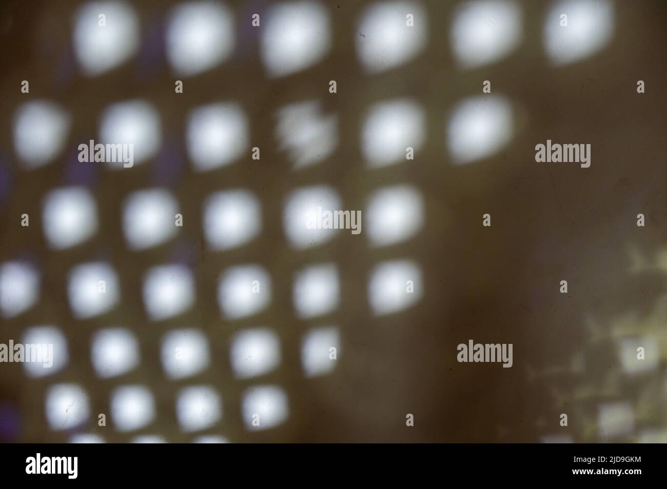 Repetitive Geometric pattern of light spots on the wall. Abstract light ...