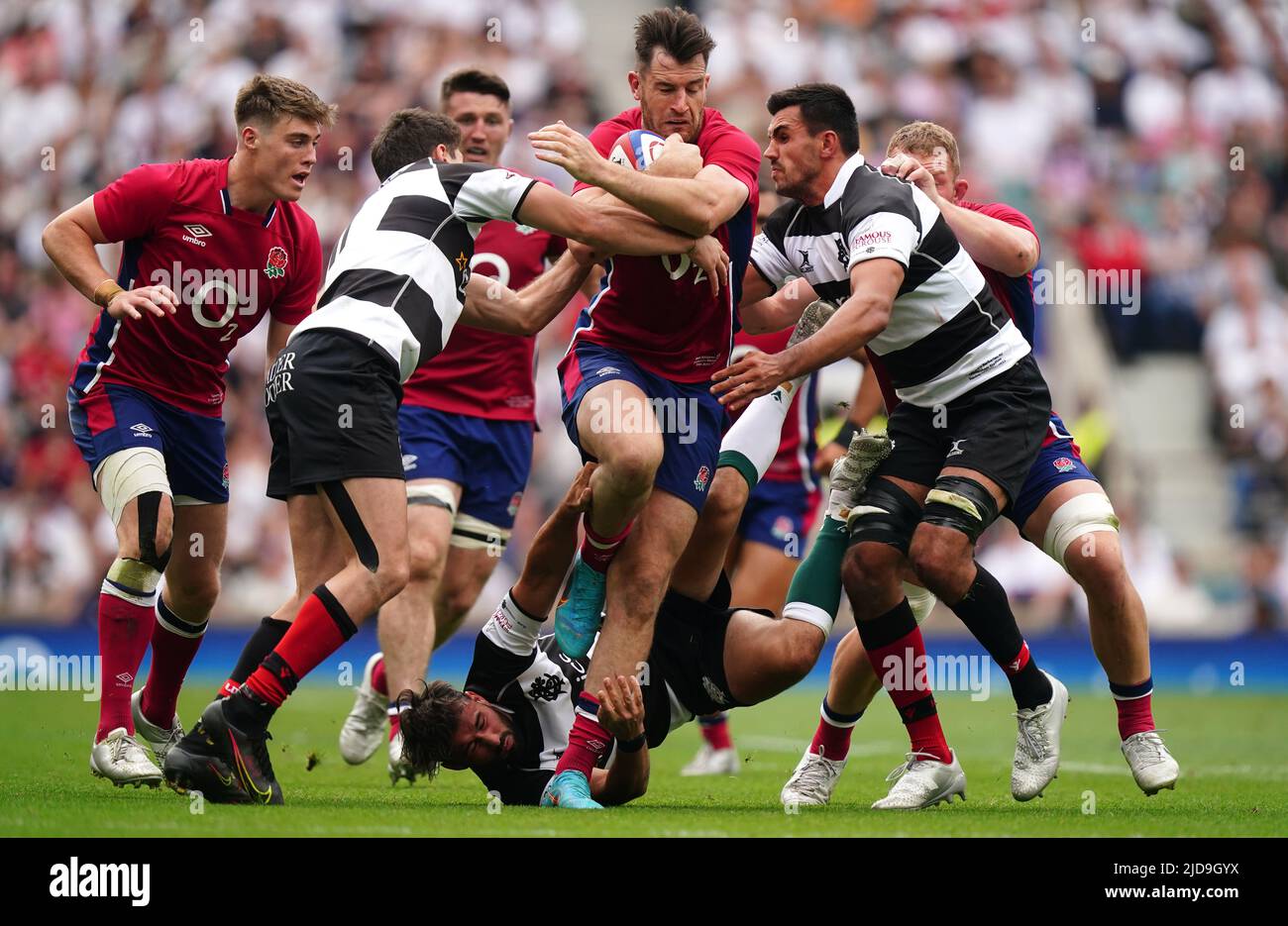 England's Mark Atkinson (left) in action with Barbarians' Davit ...
