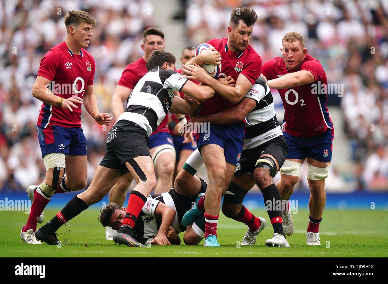 England's Mark Atkinson (left) in action with Barbarians' Davit ...
