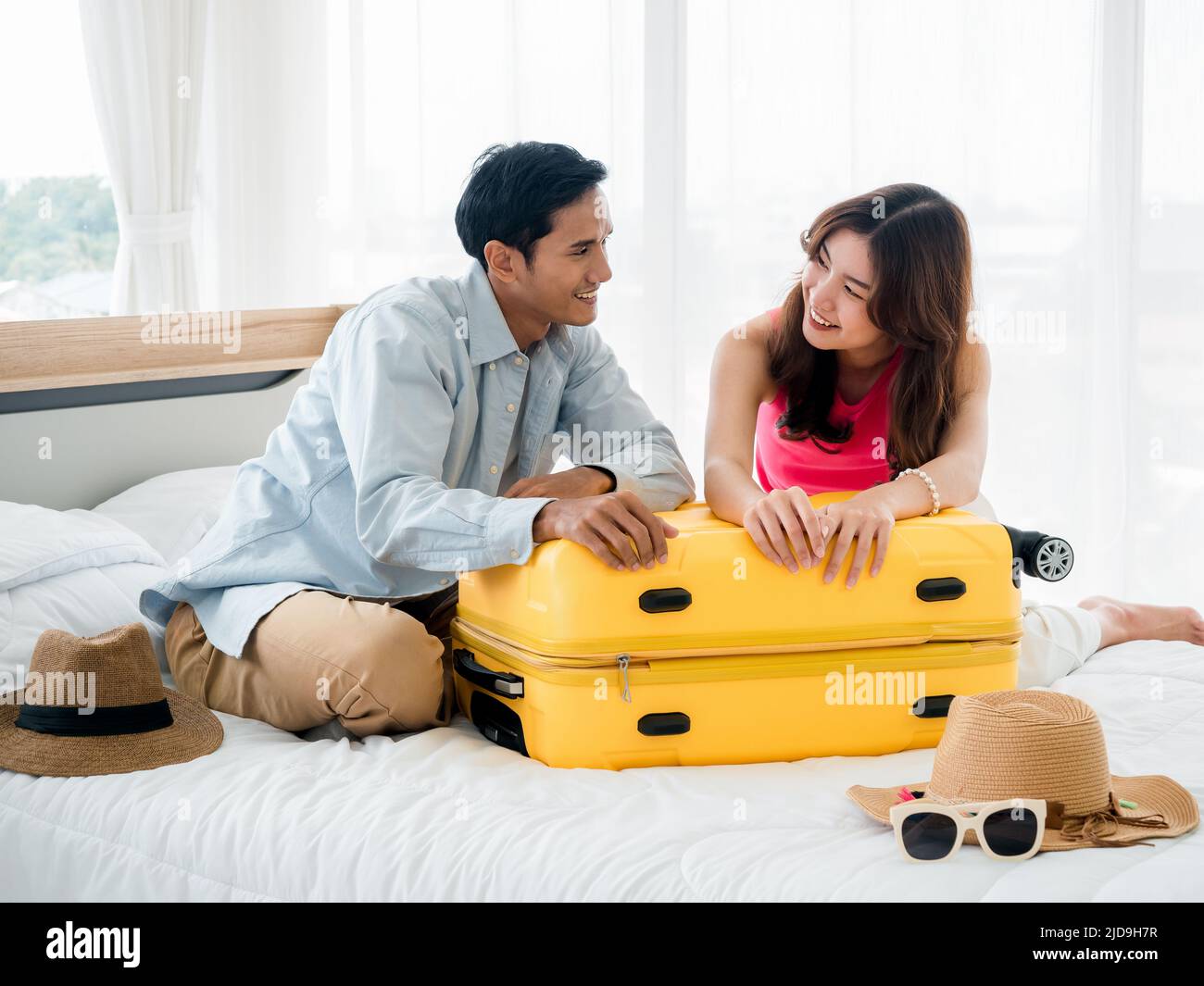 Man in bedroom packing bag hi-res stock photography and images - Alamy