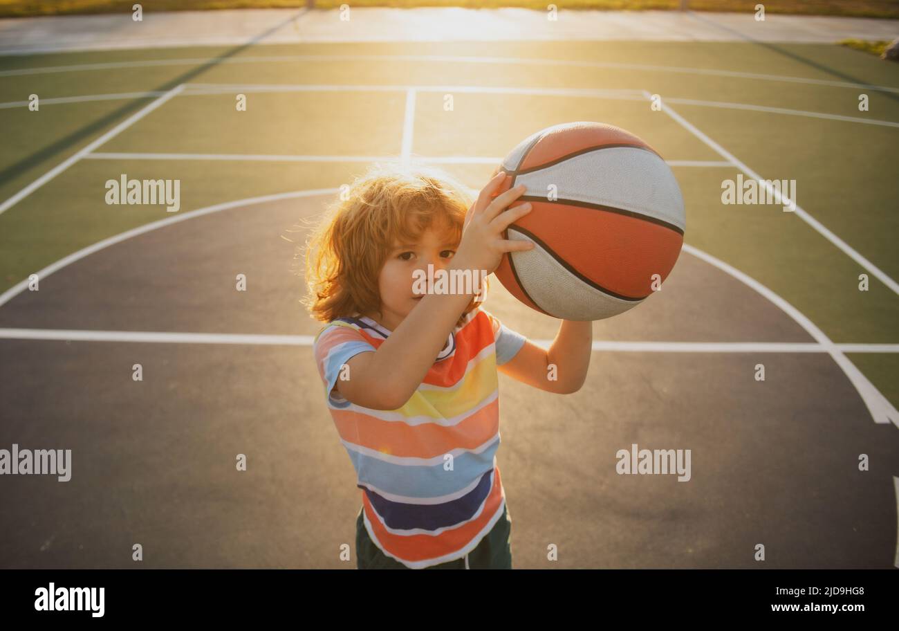 Kid child boy playing basketball with basket ball Stock Photo - Alamy