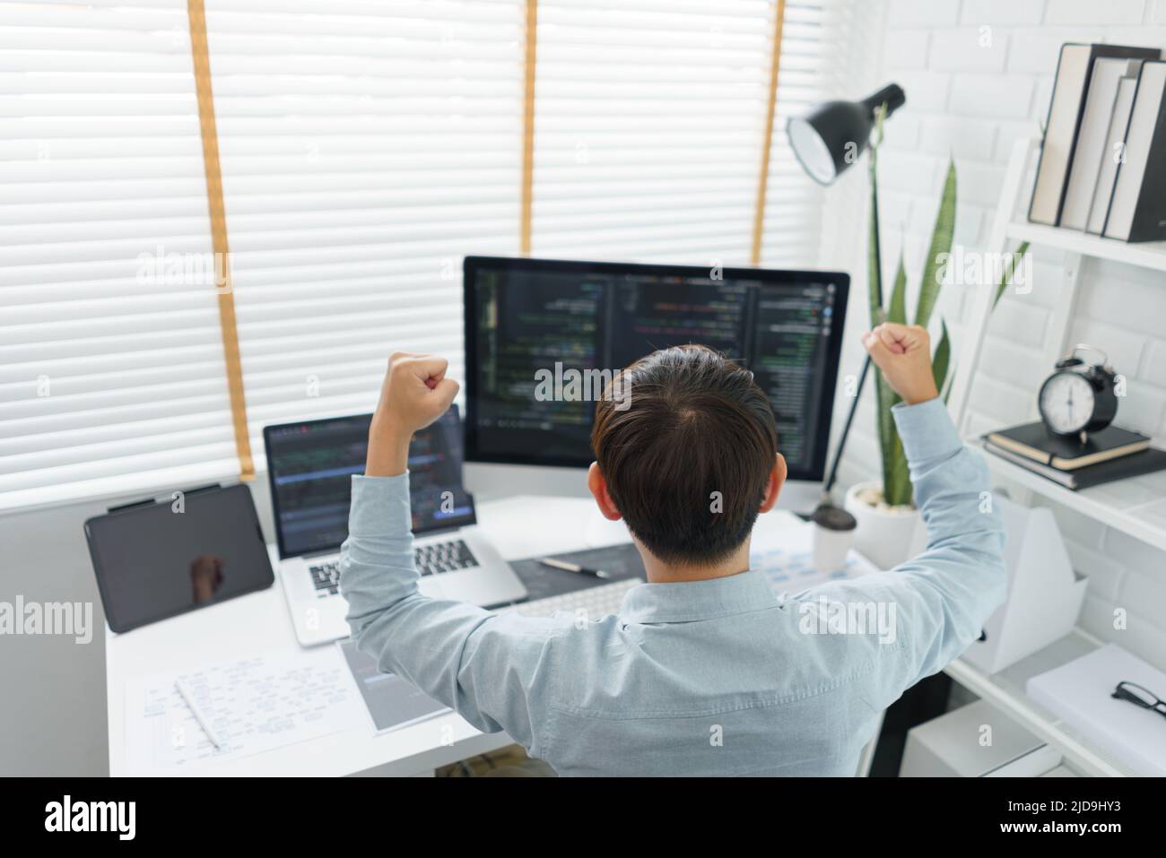 Software development concept, Male programmer excited and raise arms after successful ...