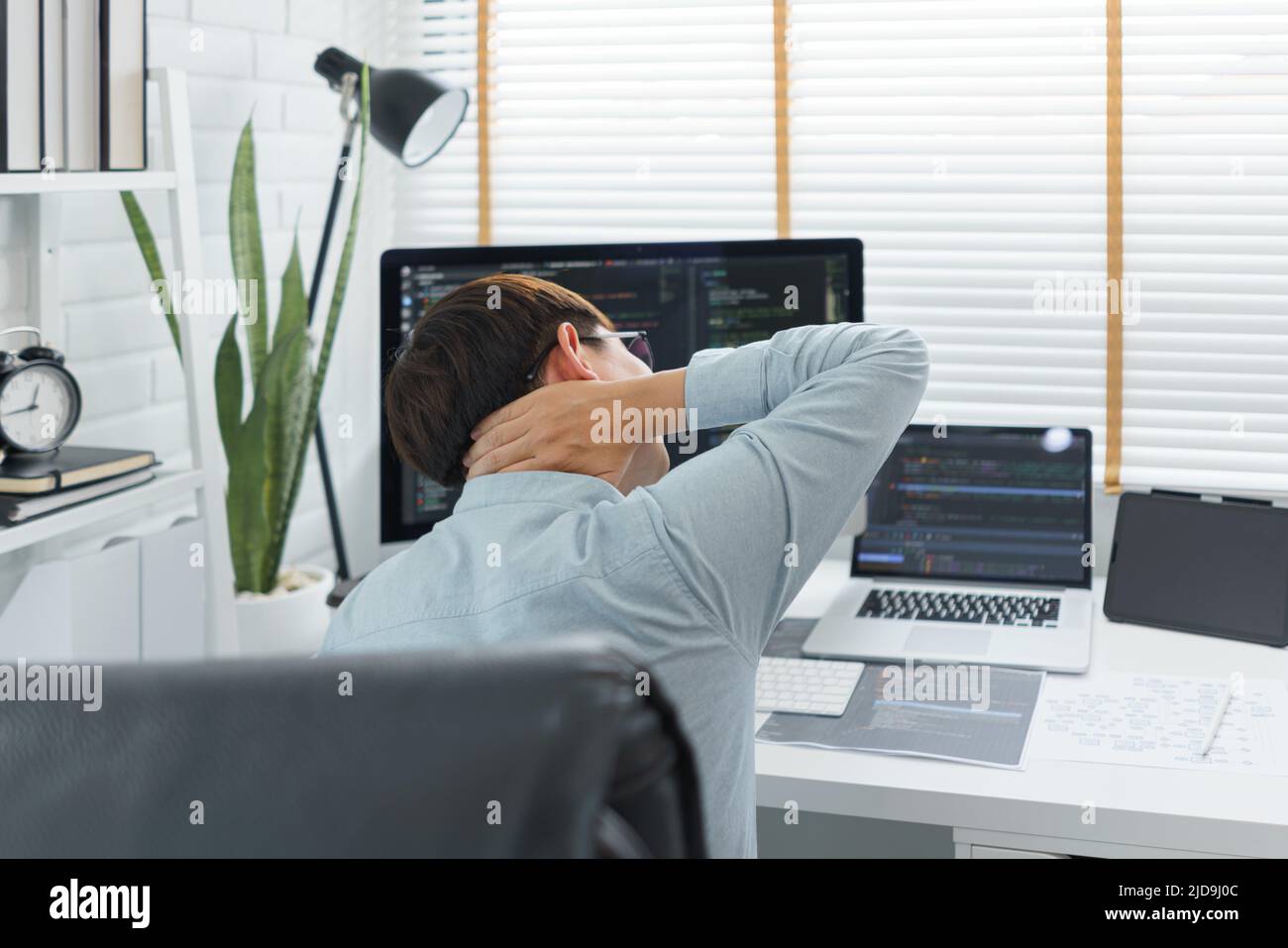 Software development concept, Male programmer suffering neck pain after ...