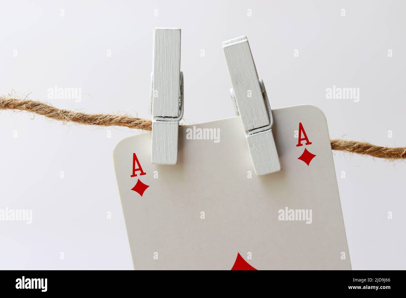 Playing cards hanging on clothesline Stock Photo - Alamy
