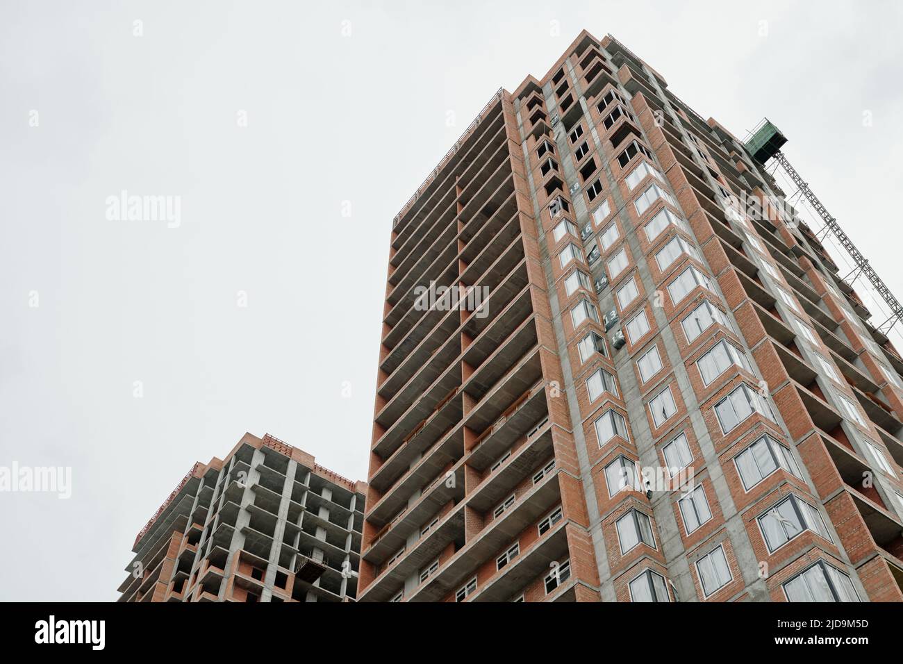 Below view of unfinished building of skyscraper or highrise condo ...