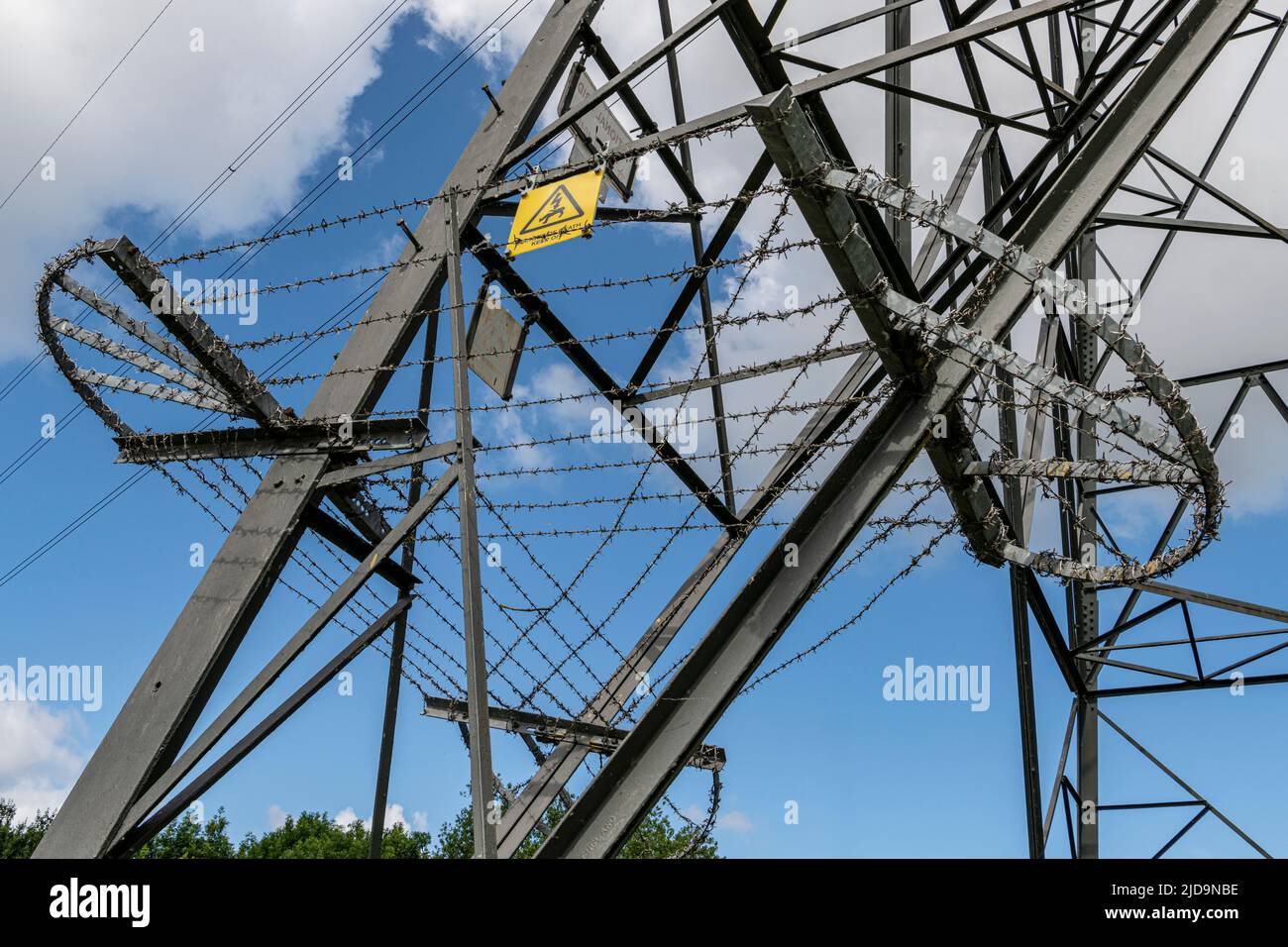Electric pylon keep off barbed wire guard Stock Photo - Alamy