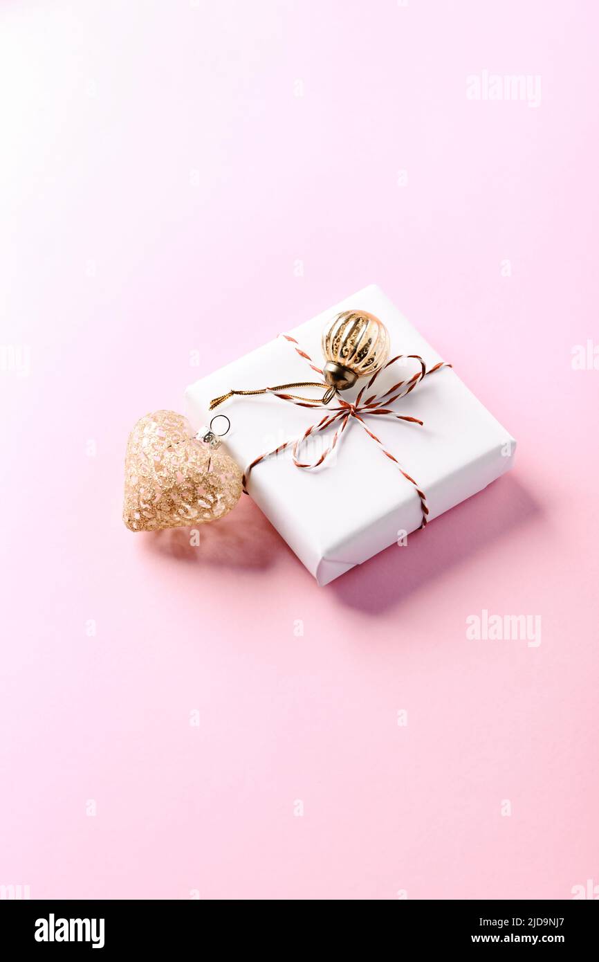 Christmas baubles and Christmas present. Bright paper background. Copy ...