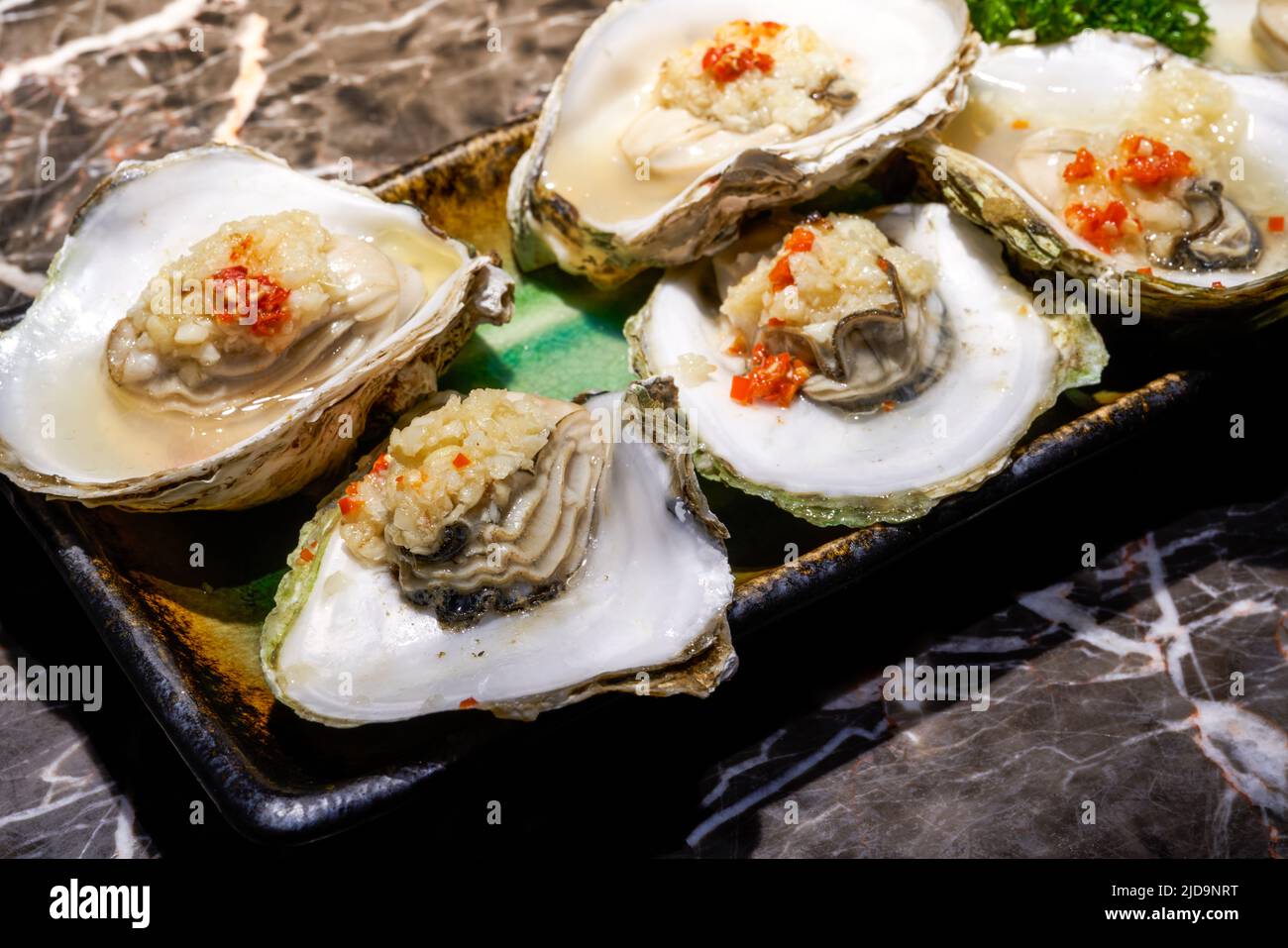 A delicious Japanese dish, steamed oysters with garlic Stock Photo - Alamy
