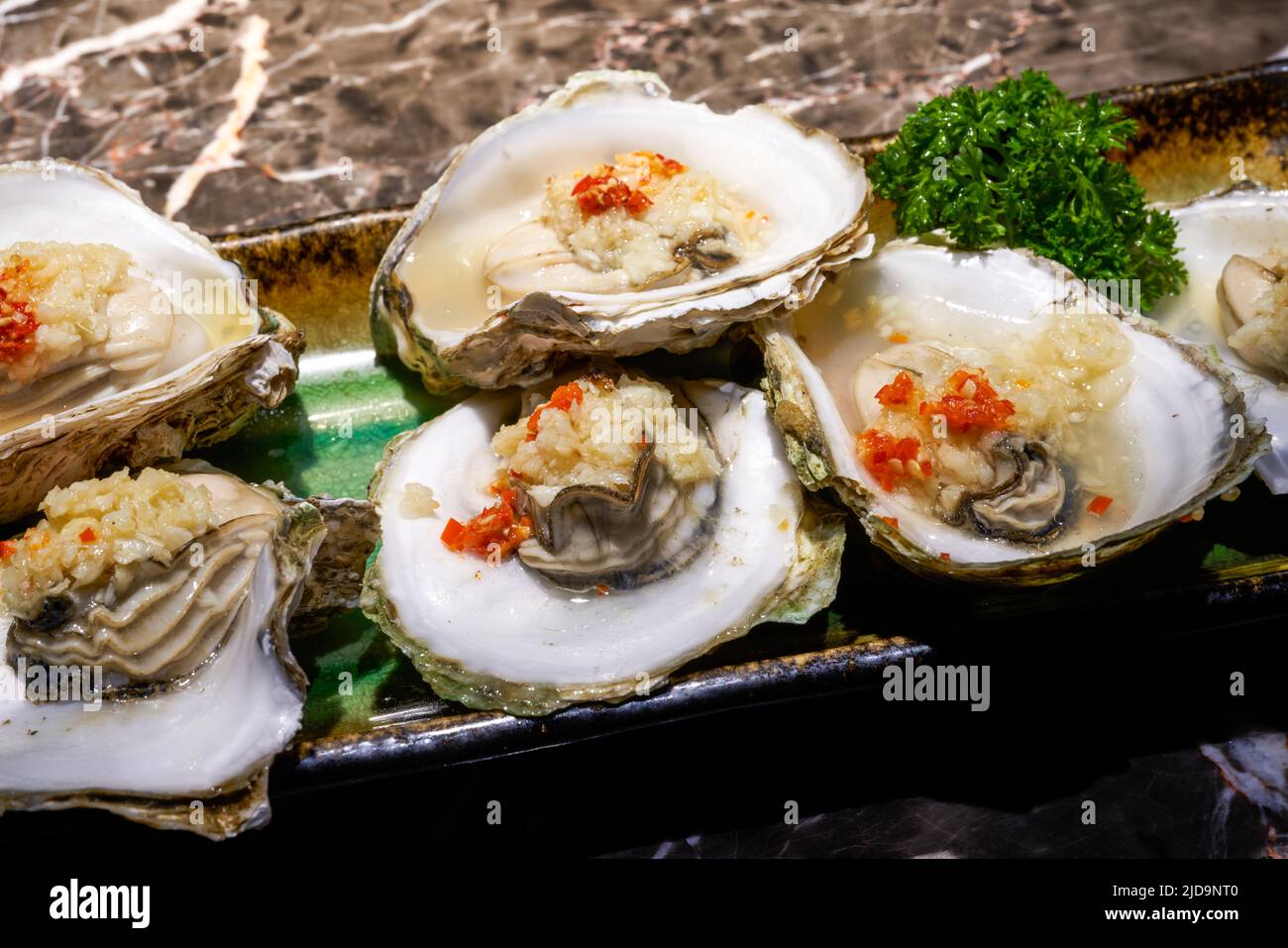 A delicious Japanese dish, steamed oysters with garlic Stock Photo - Alamy