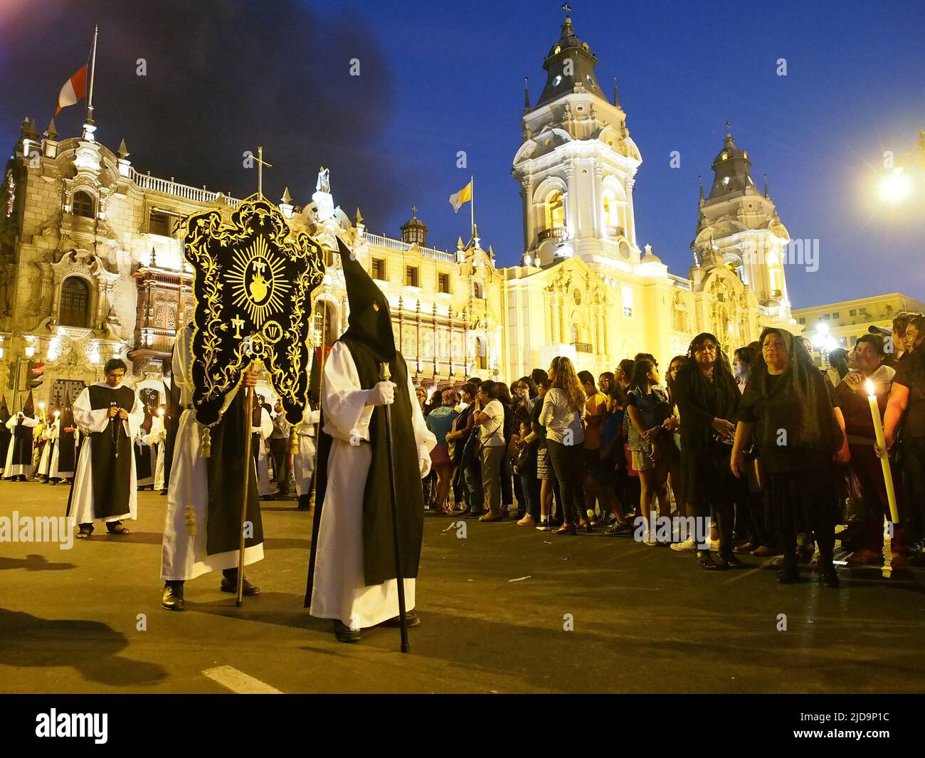 Catholic devotees carrying on a religious procession at eve on Holy ...