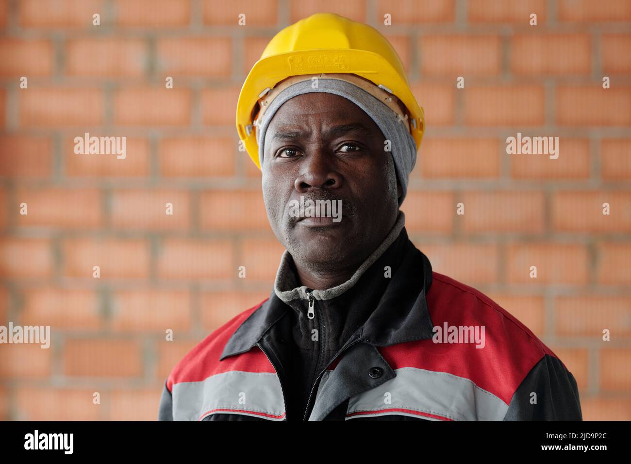 Serious mature African American foreman in workwear and protective ...