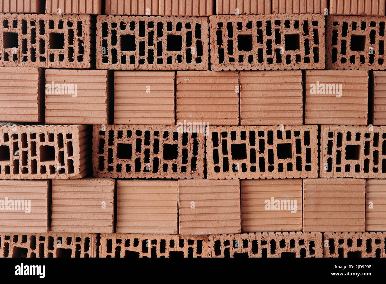 Stack of red solid clay bricks formed by several layers prepared for ...