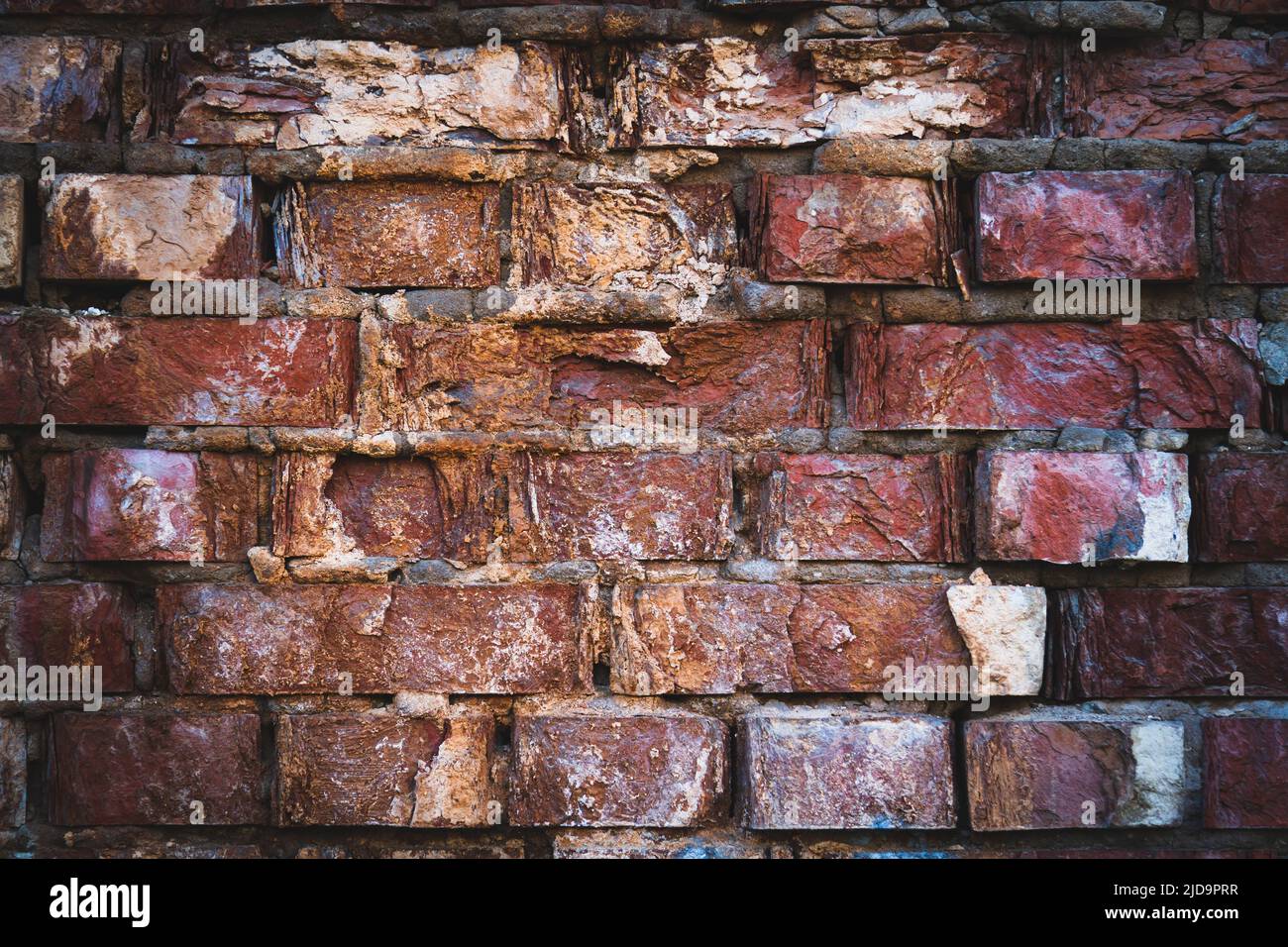 Stone wall with deep cracks. Break in the ground. Drought and ...