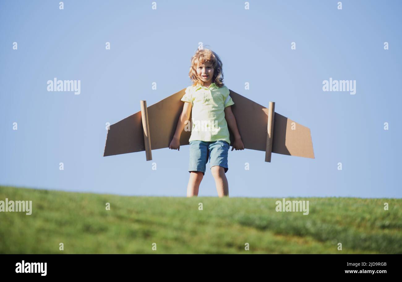 Child to be pilot. Kid with paper wings flying. Summer vacation and ...