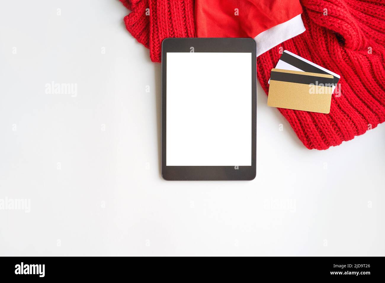 Plastic credit card mockup and tablet. Color red and white background ...