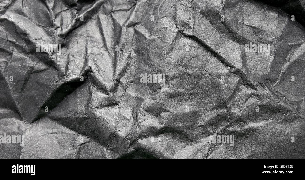 Crumpled black paper texture background Stock Photo - Alamy