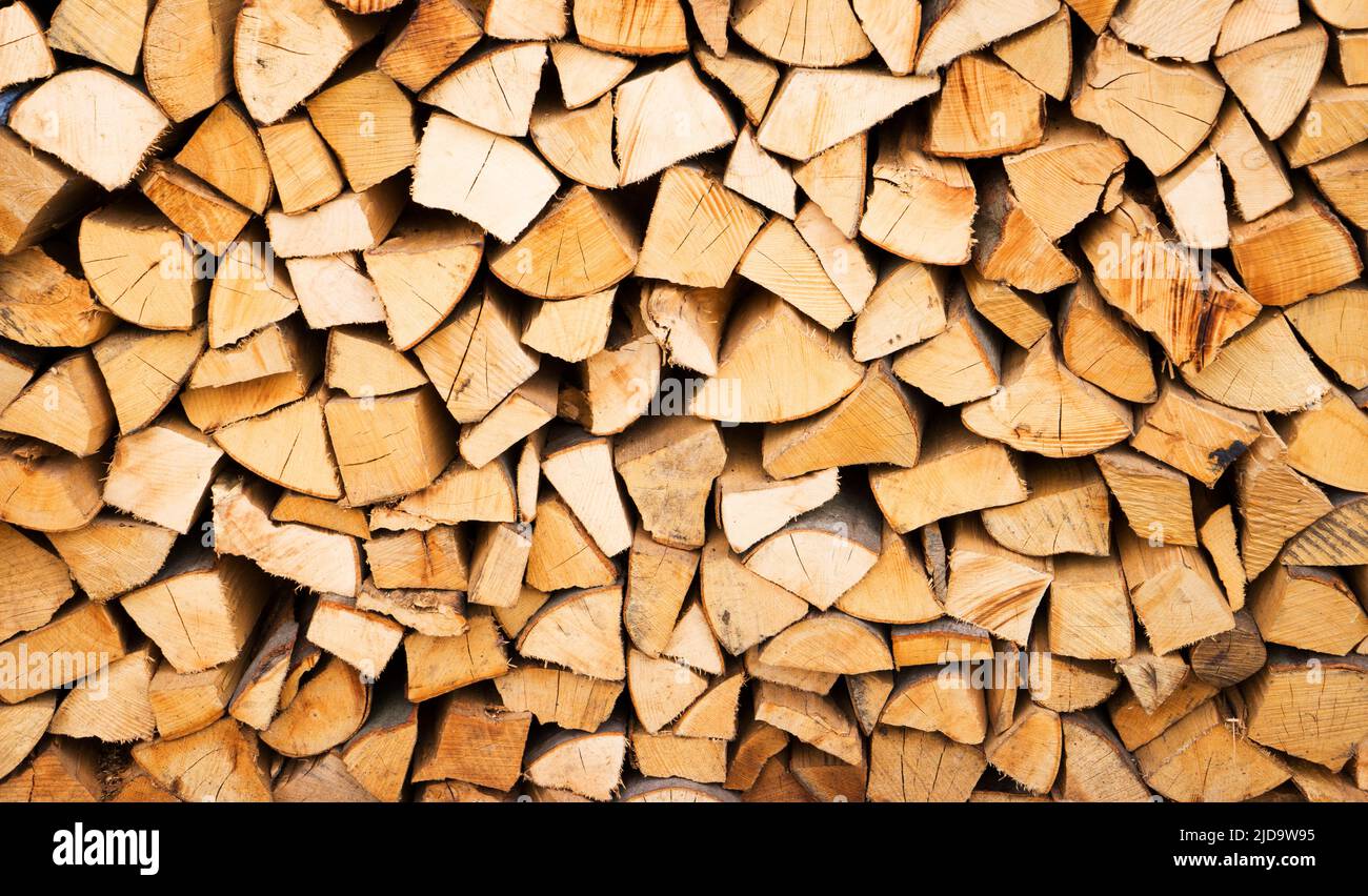 Close up wood pile shaped like a wall outside. Ready for winter ...