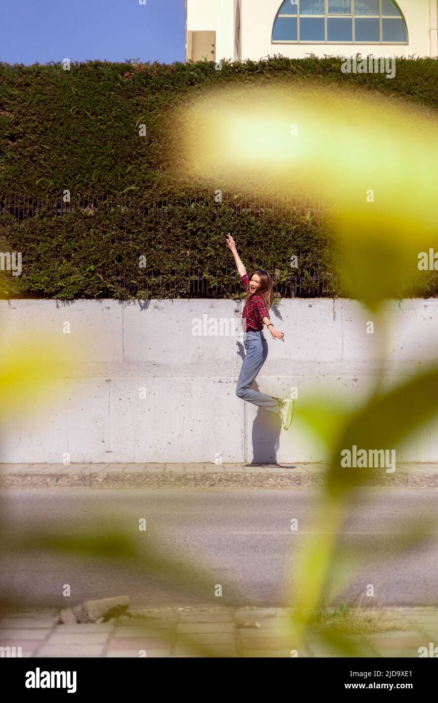 Beautiful girl jumping on the road Stock Photo - Alamy