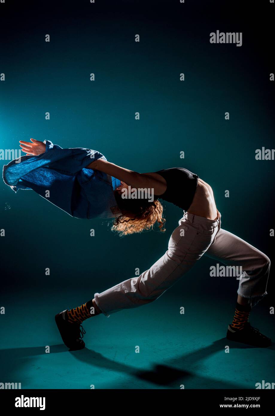 Flexible young dancer performing a stylish dance movement Stock Photo ...