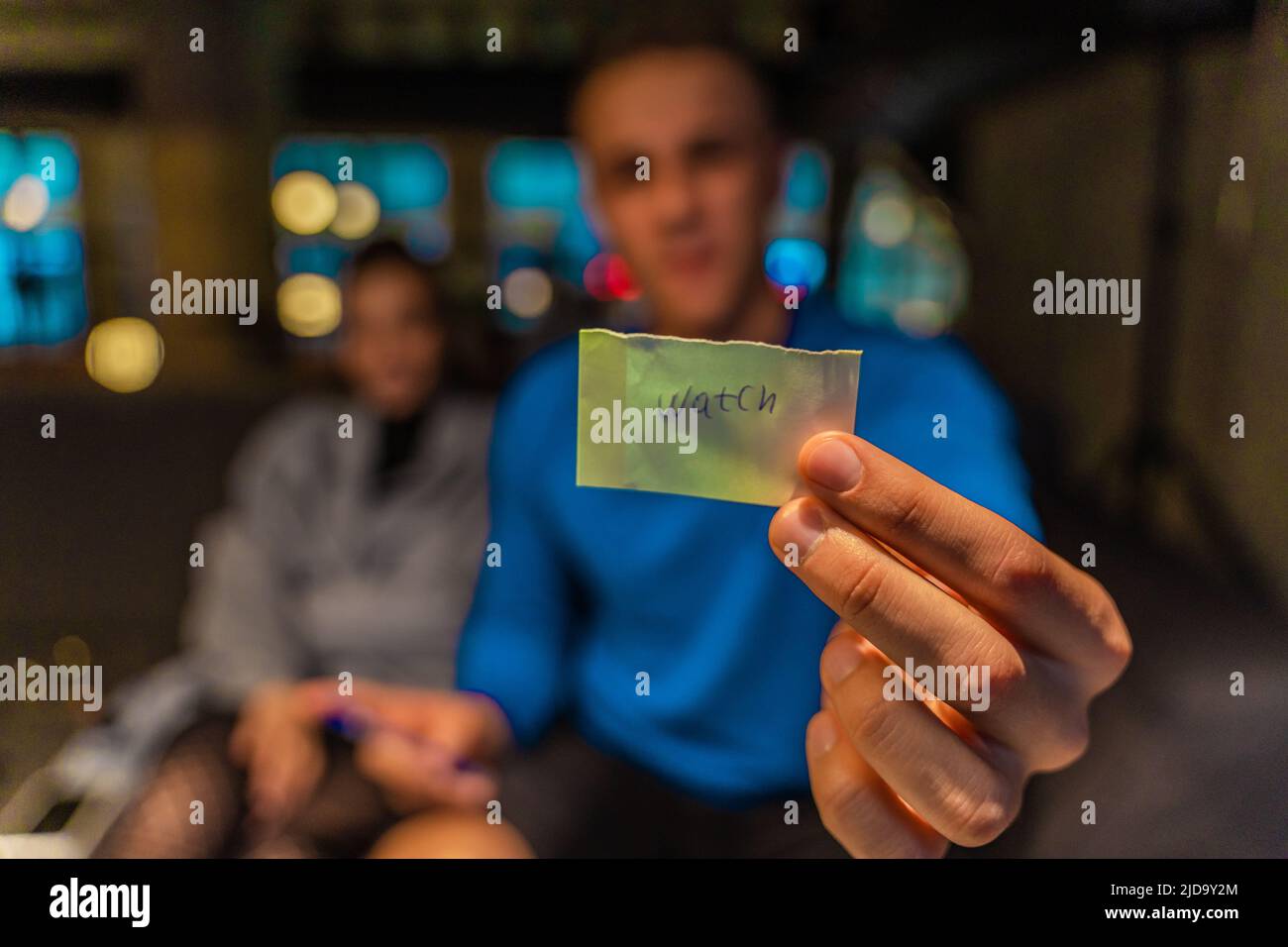 Friends are writing words on the paper for the guessing game Stock ...