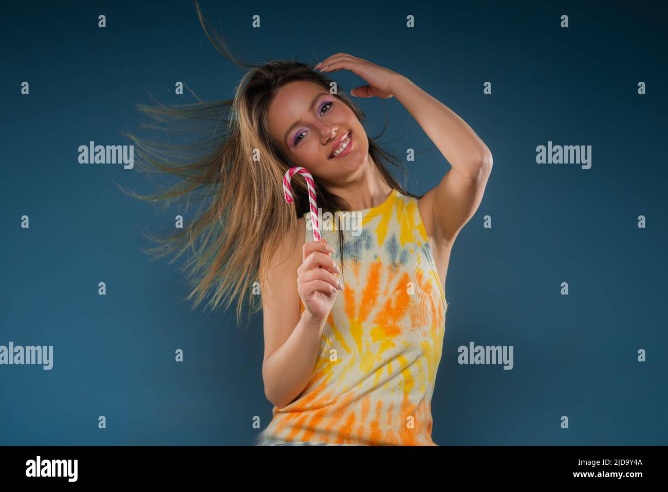 Amazing and attractive young girl is flipping her hair in studio Stock ...