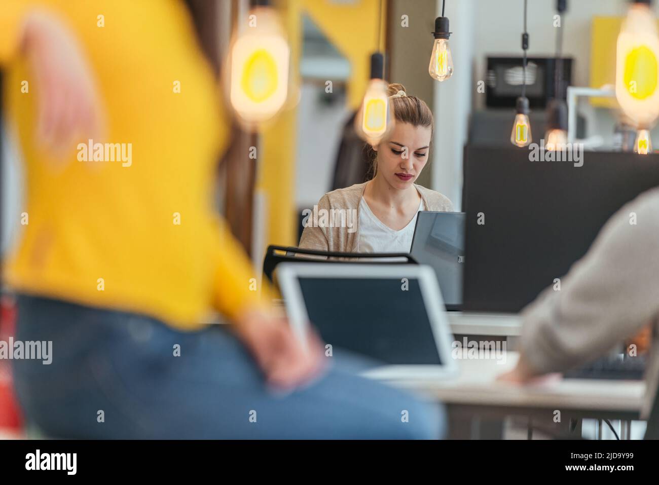 Blonde manager working behind her desk in a modern office Stock Photo ...