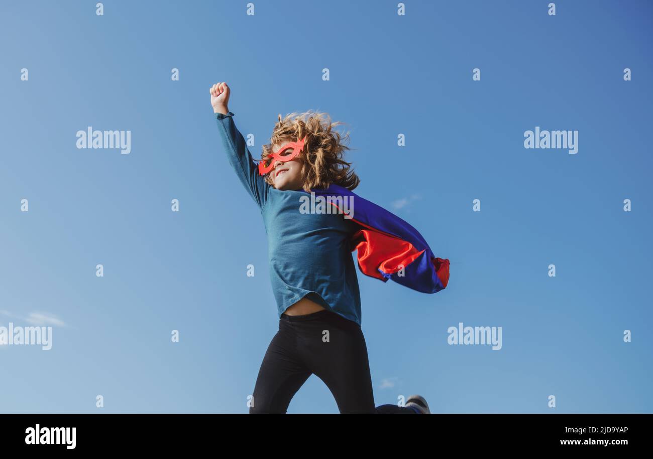 Super jump. Boy in red super hero cape and mask flying. Freedom ...