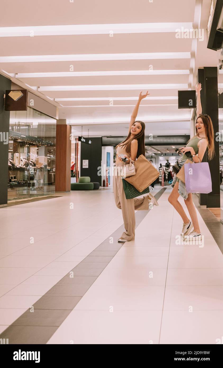 Two pretty girls having fun at the shopping mall Stock Photo - Alamy