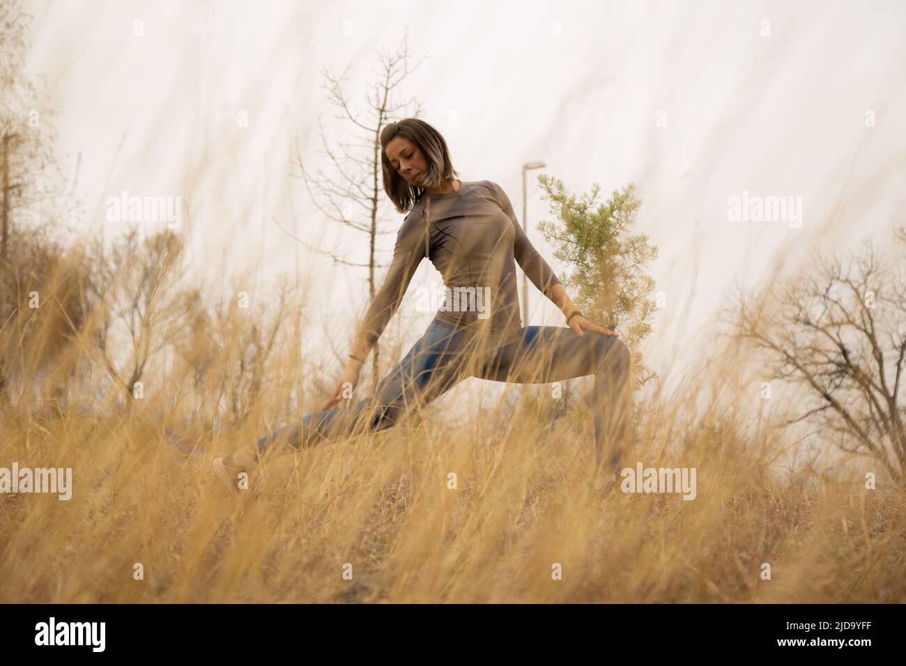 Amazing woman stretching in nature Stock Photo - Alamy