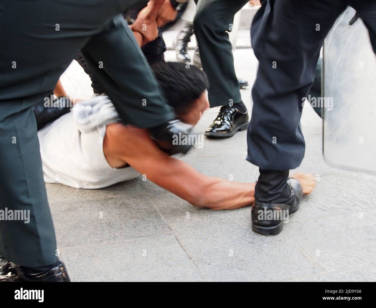 Riot police kick the face of a fallen protester during a demonstration ...