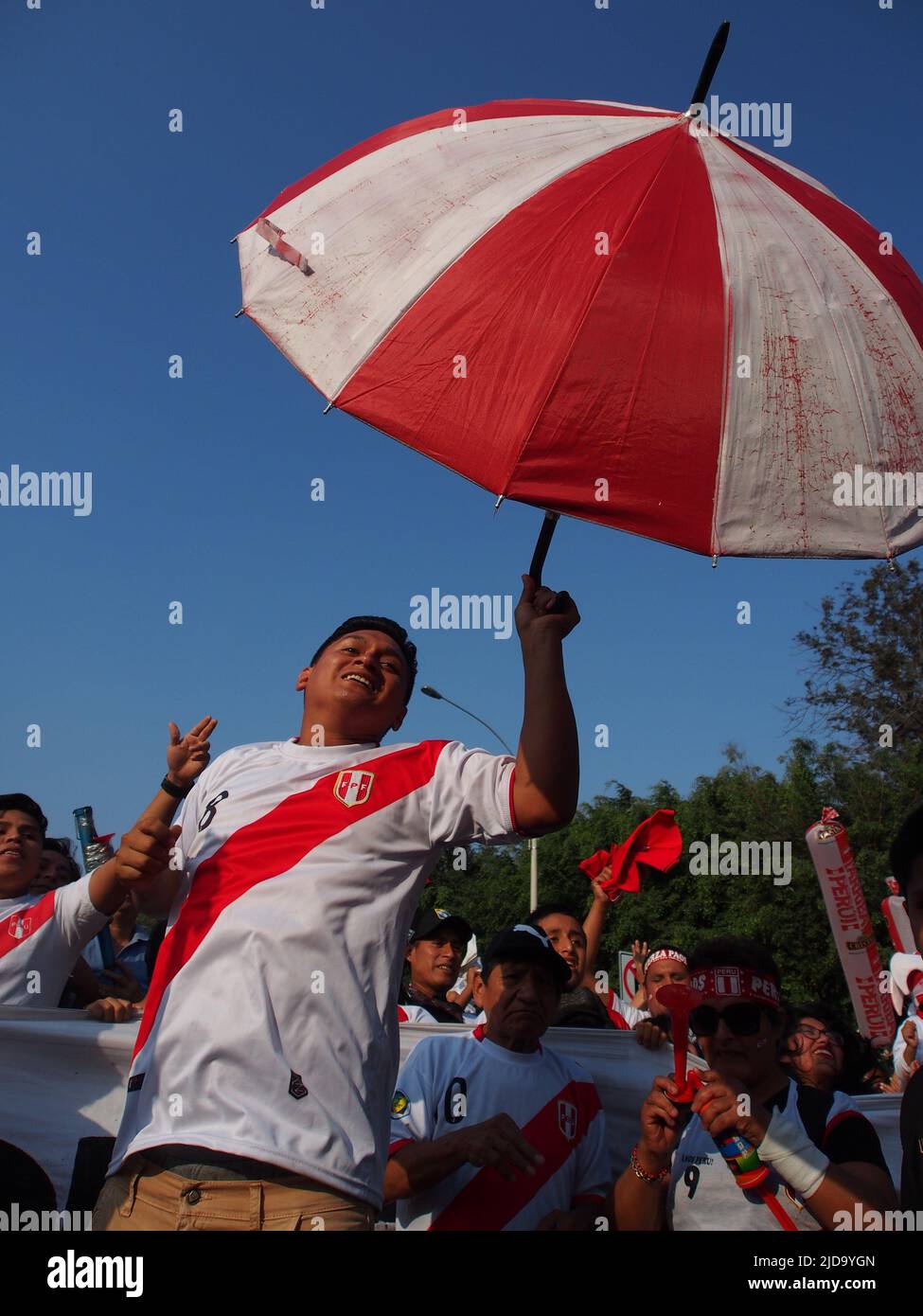 A man with a Peruvian jersey and an umbrella, when thousands of ...