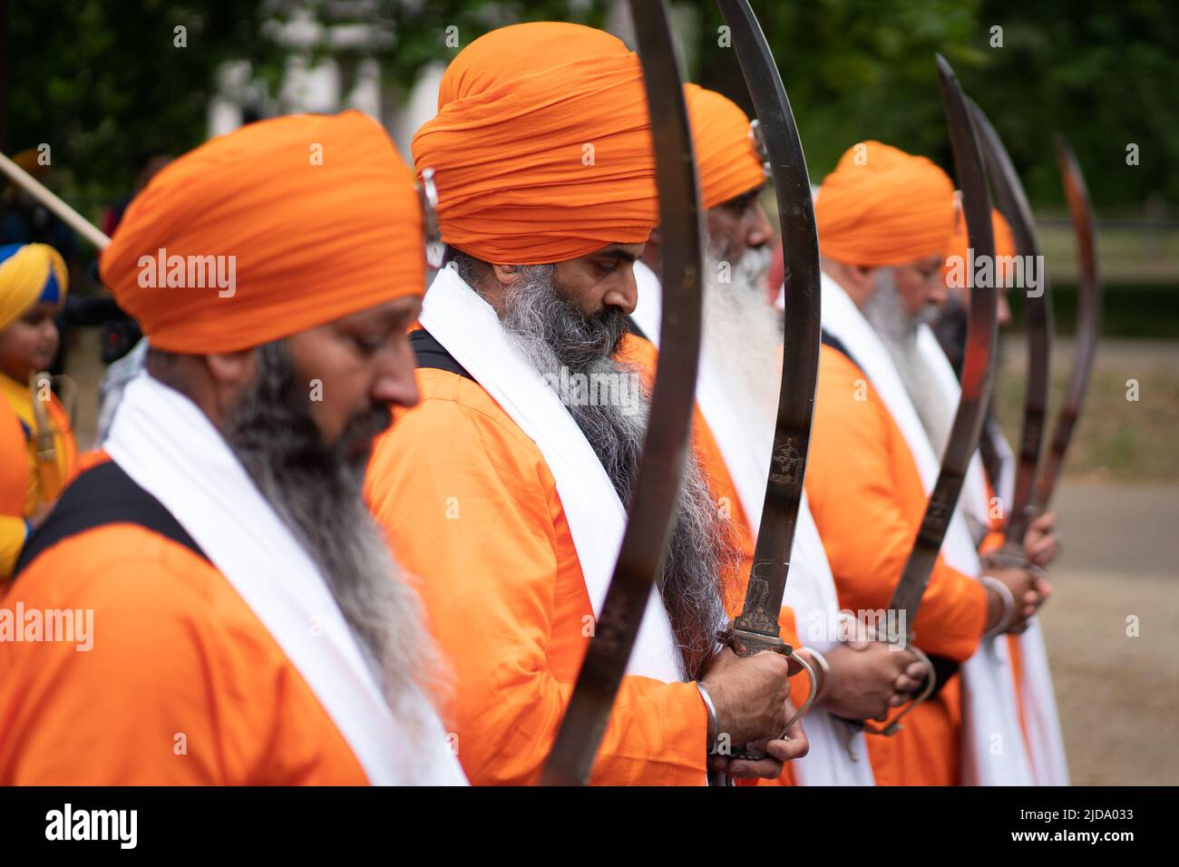 Sikh men hold their swords as they march along The Mall to Trafalgar ...