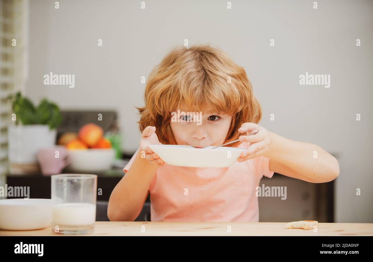 Caucasian toddler child boy eating healthy soup in the kitchen. Child ...