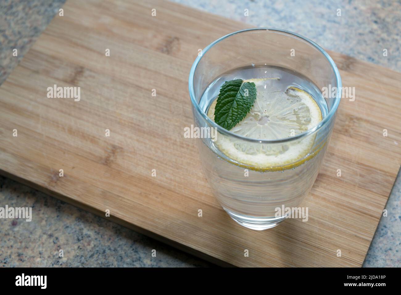 Summer refreshment: glass with water, lemon and mint Stock Photo - Alamy
