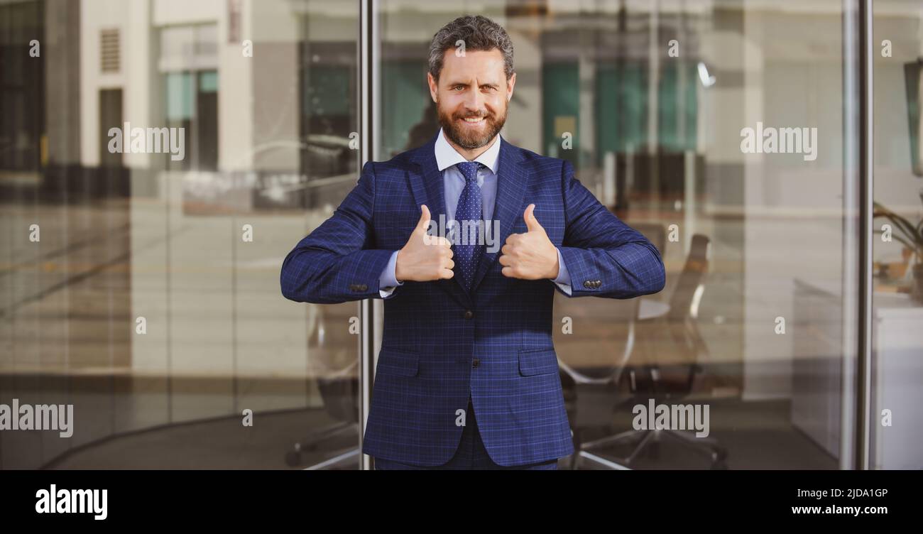 Businessman giving thumbs up. Business man going thumb up near the ...
