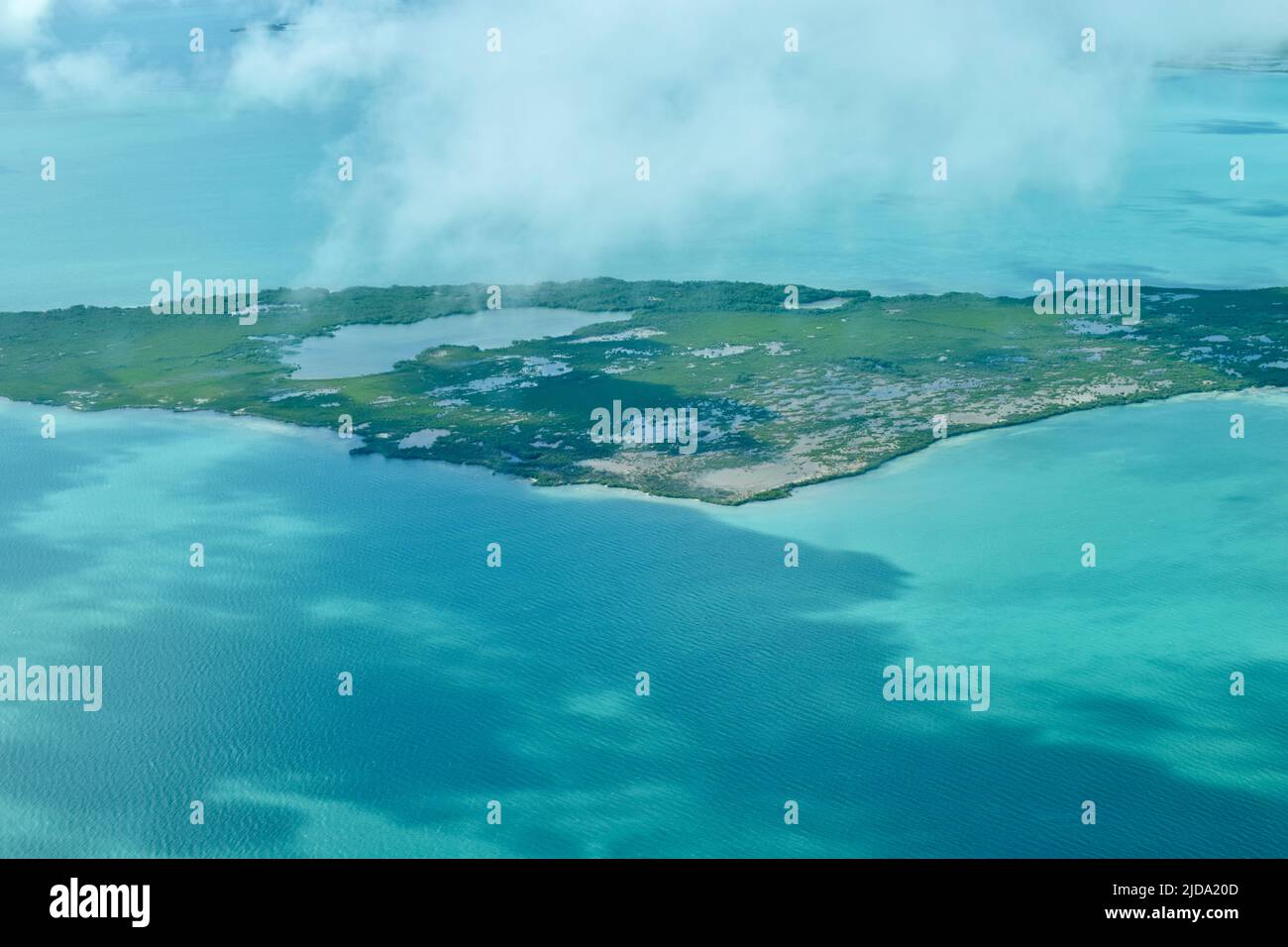 Aerial view of an atoll surrounded by clear, turquoise water in Belize ...