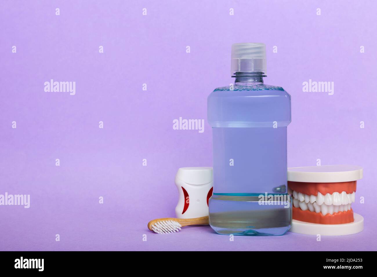 Mouthwash and other oral hygiene products on colored table top view ...